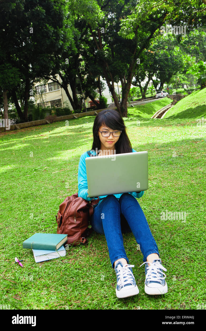 College Student using computer in university park outdoor Stock Photo ...