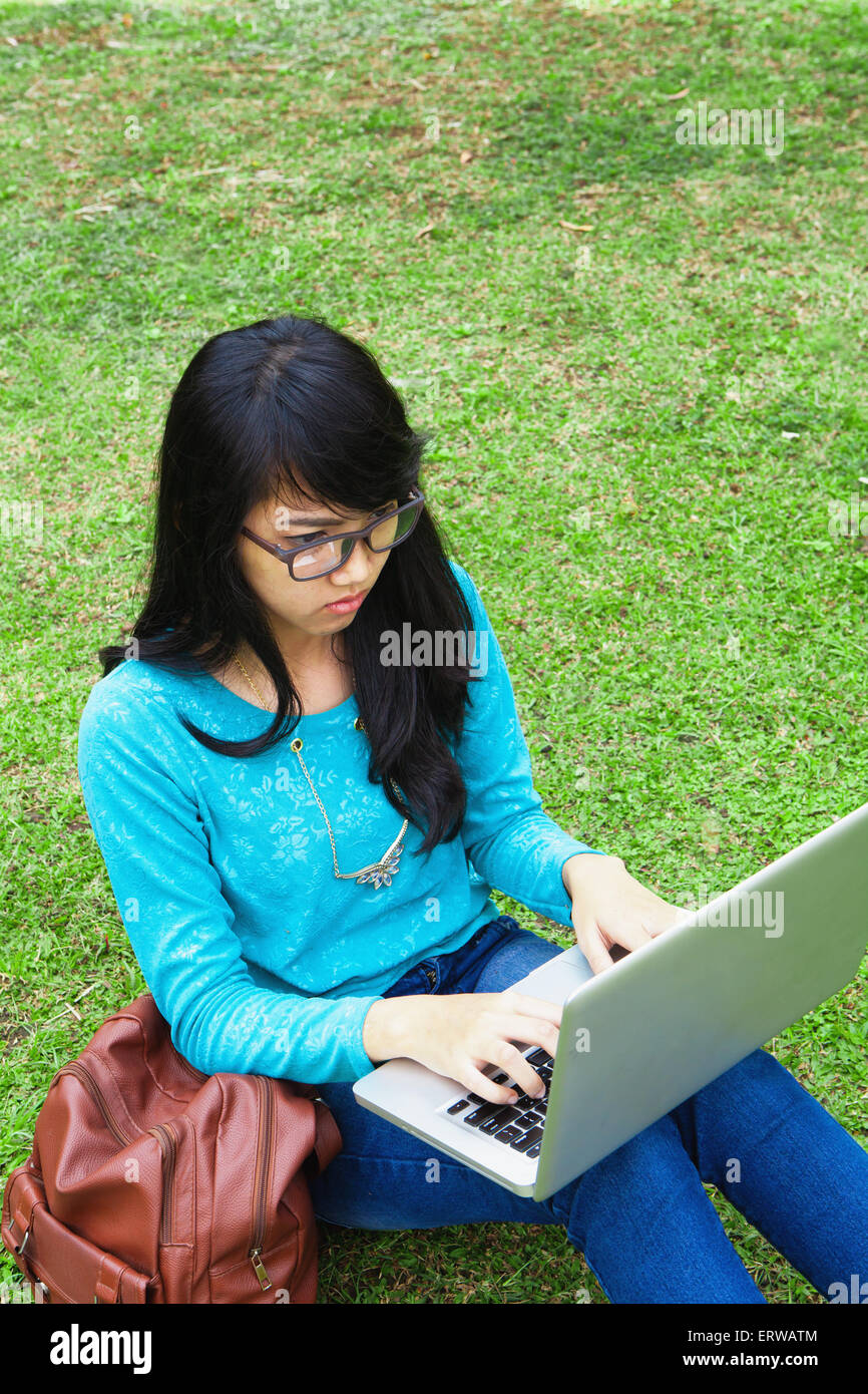 College Student using computer in university park outdoor Stock Photo ...