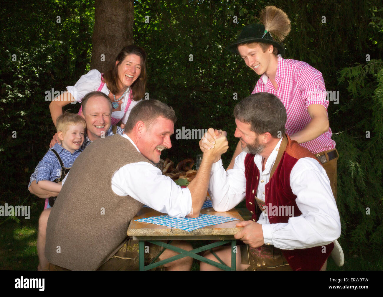 two bavarian men pressing hands while people watching Stock Photo - Alamy