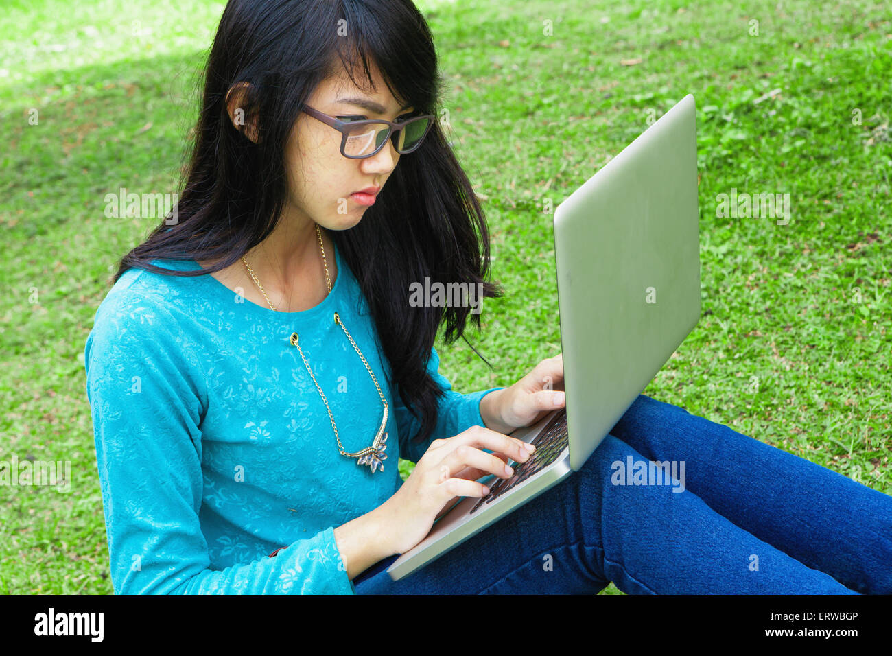 College Student using computer in university park outdoor Stock Photo ...