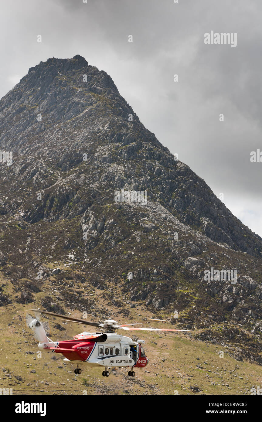 A Bristow SAR helicopter hovers at the foot of Tryfan. The Coastguard ...