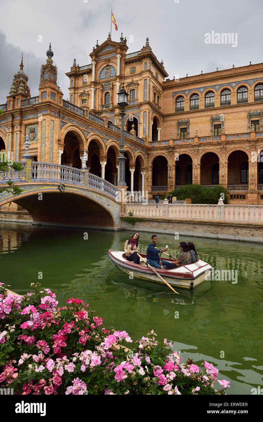 Tourists in rowboat hamming for a selfie on the canal at Plaza de ...