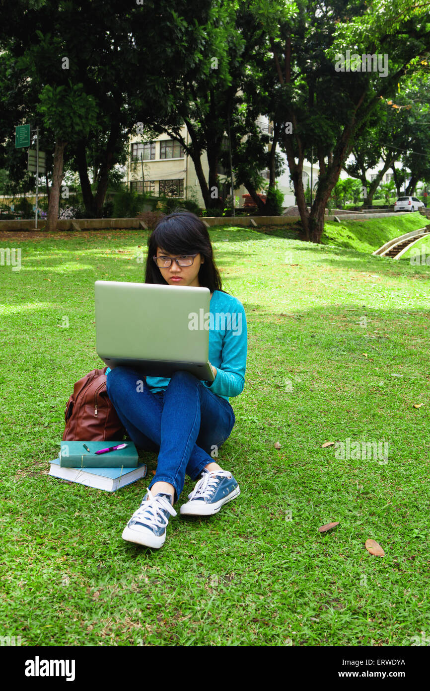 College Student using computer in university park outdoor Stock Photo ...