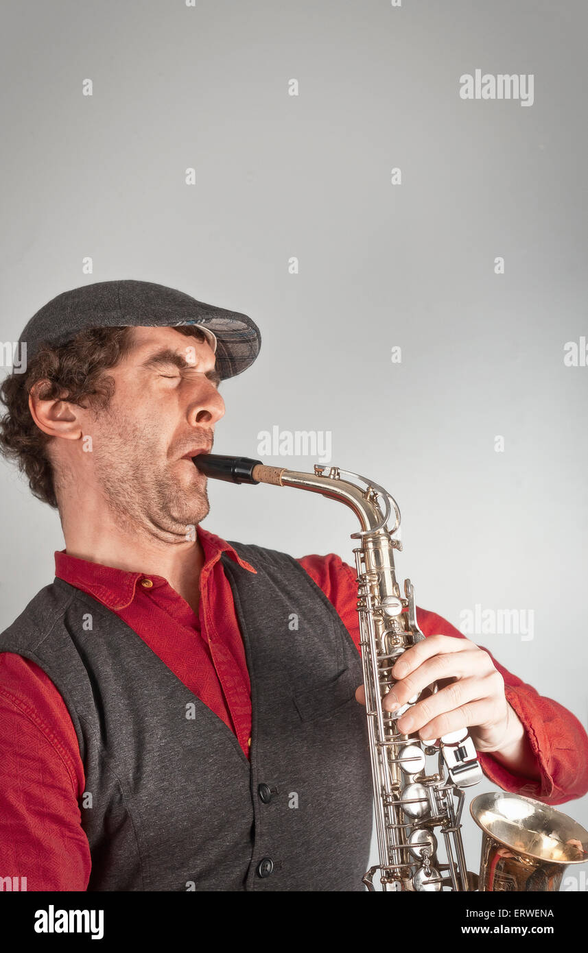 Ugly man wails on saxophone while dressed as a beatnik Stock Photo - Alamy