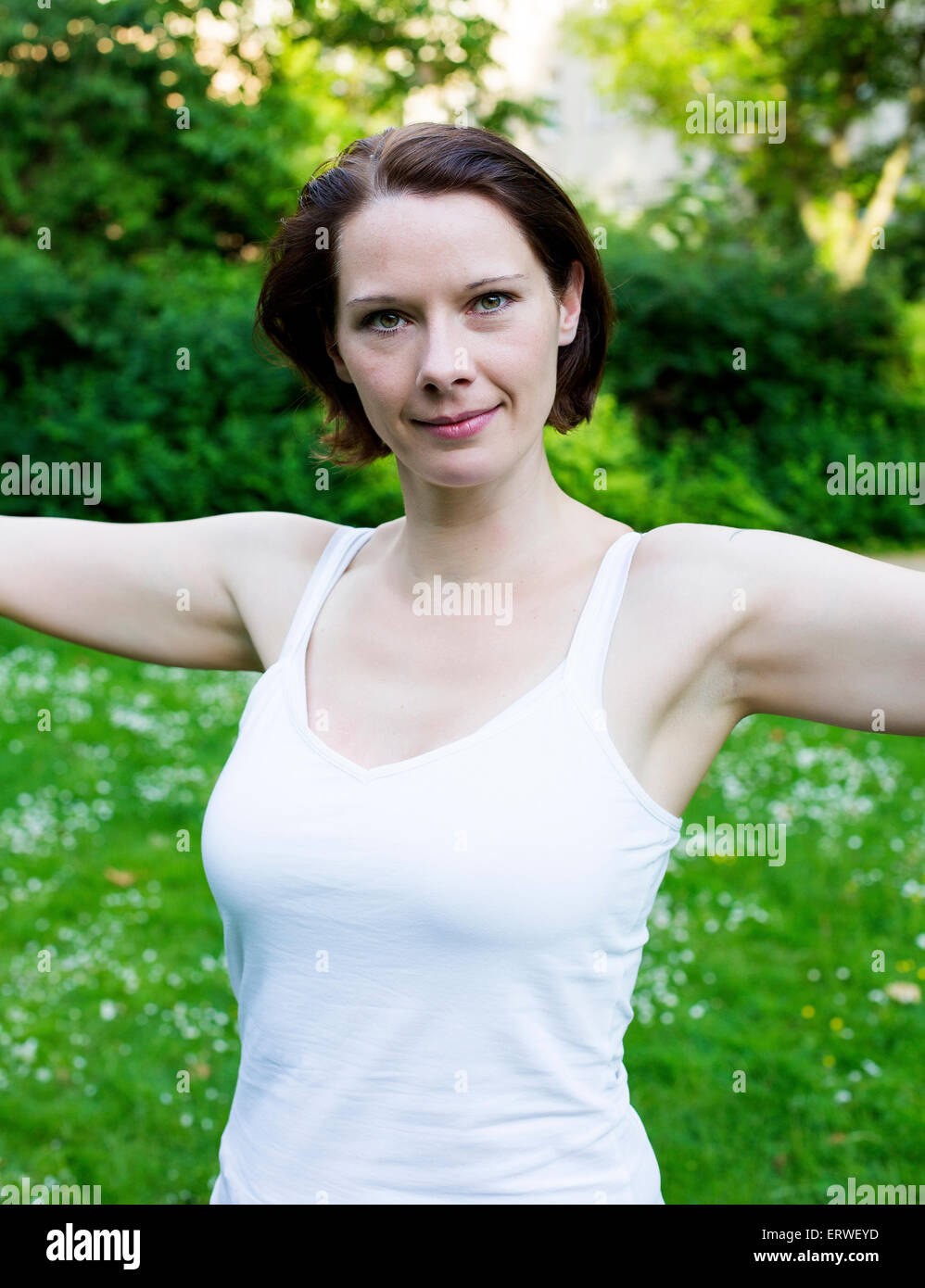 woman in park spreading her arms and smiling Stock Photo - Alamy