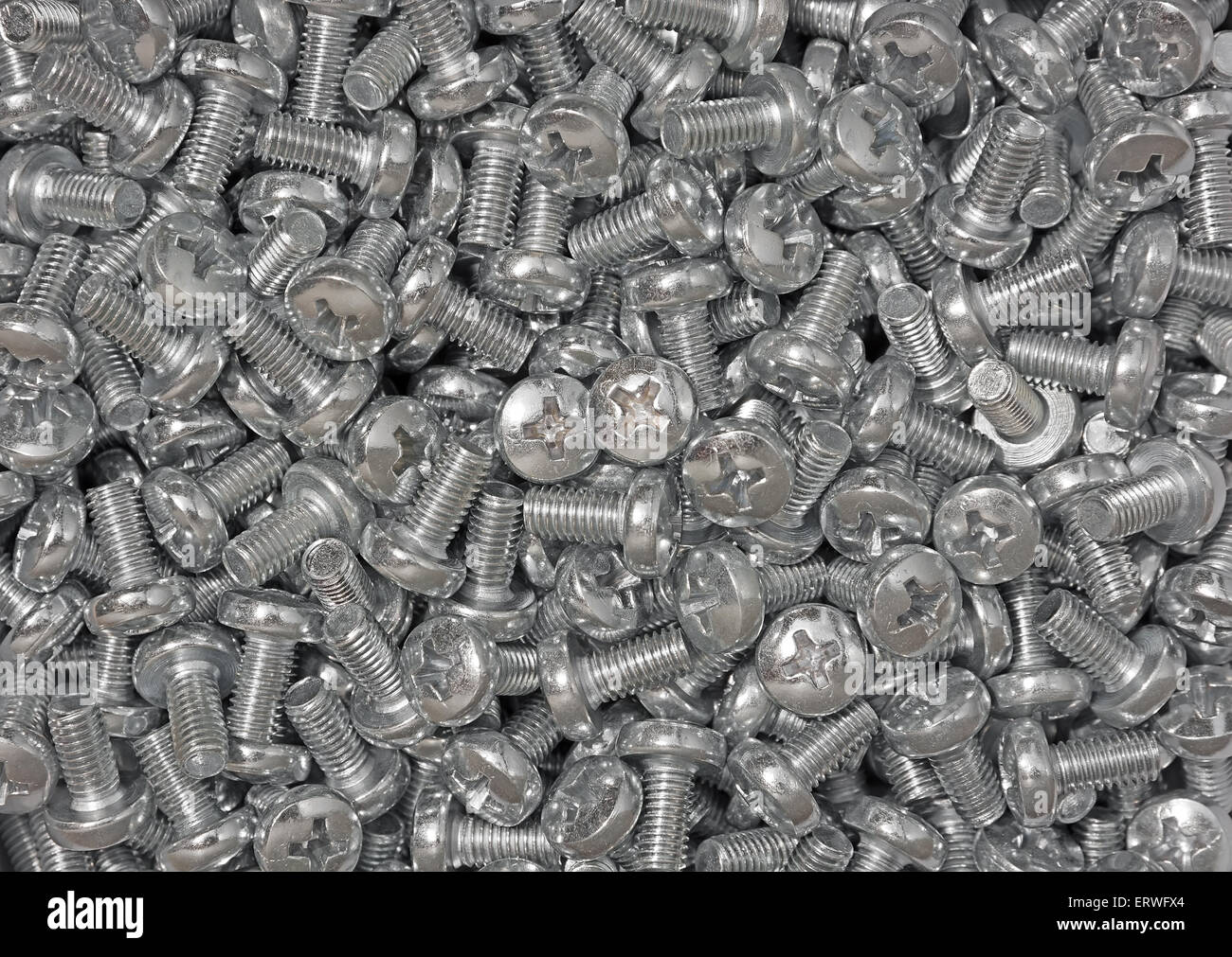 Pile of shiny chrome screws. Background, texture Stock Photo - Alamy
