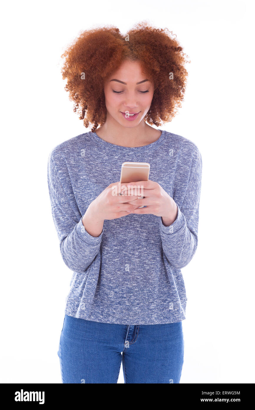 African American young woman sending a text message on her smartphone ...