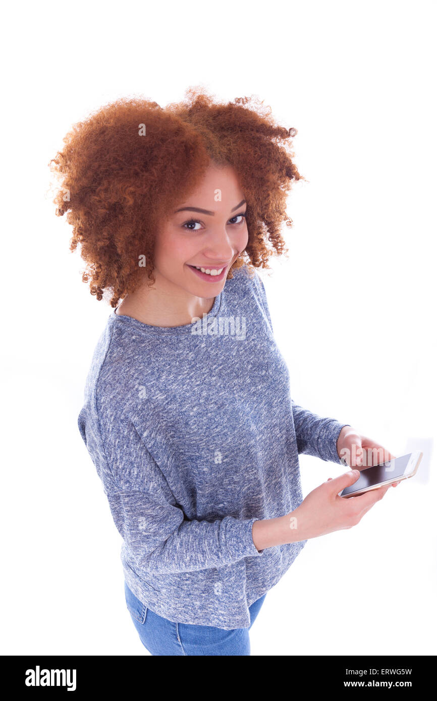 African American young woman sending a text message on her smartphone ...
