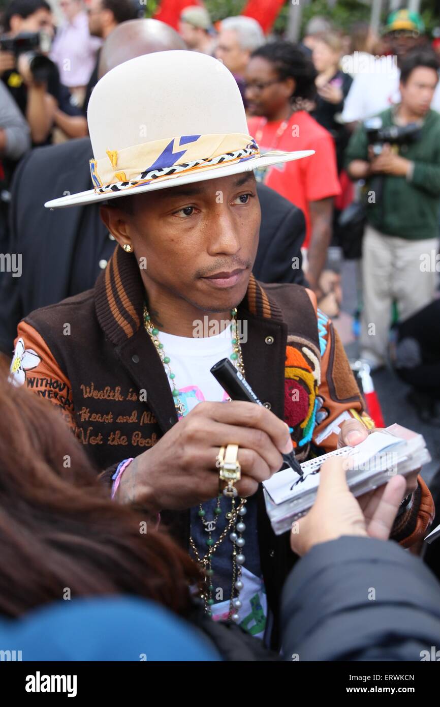 Pharrell Williams is presented with a star on the Hollywood walk of ...