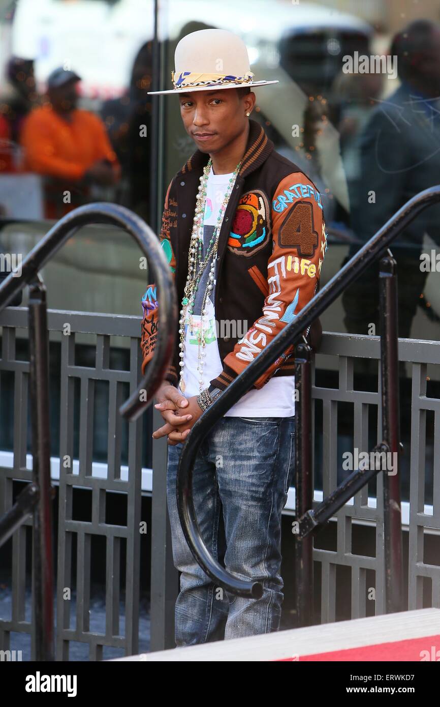 Pharrell Williams is presented with a star on the Hollywood walk of ...