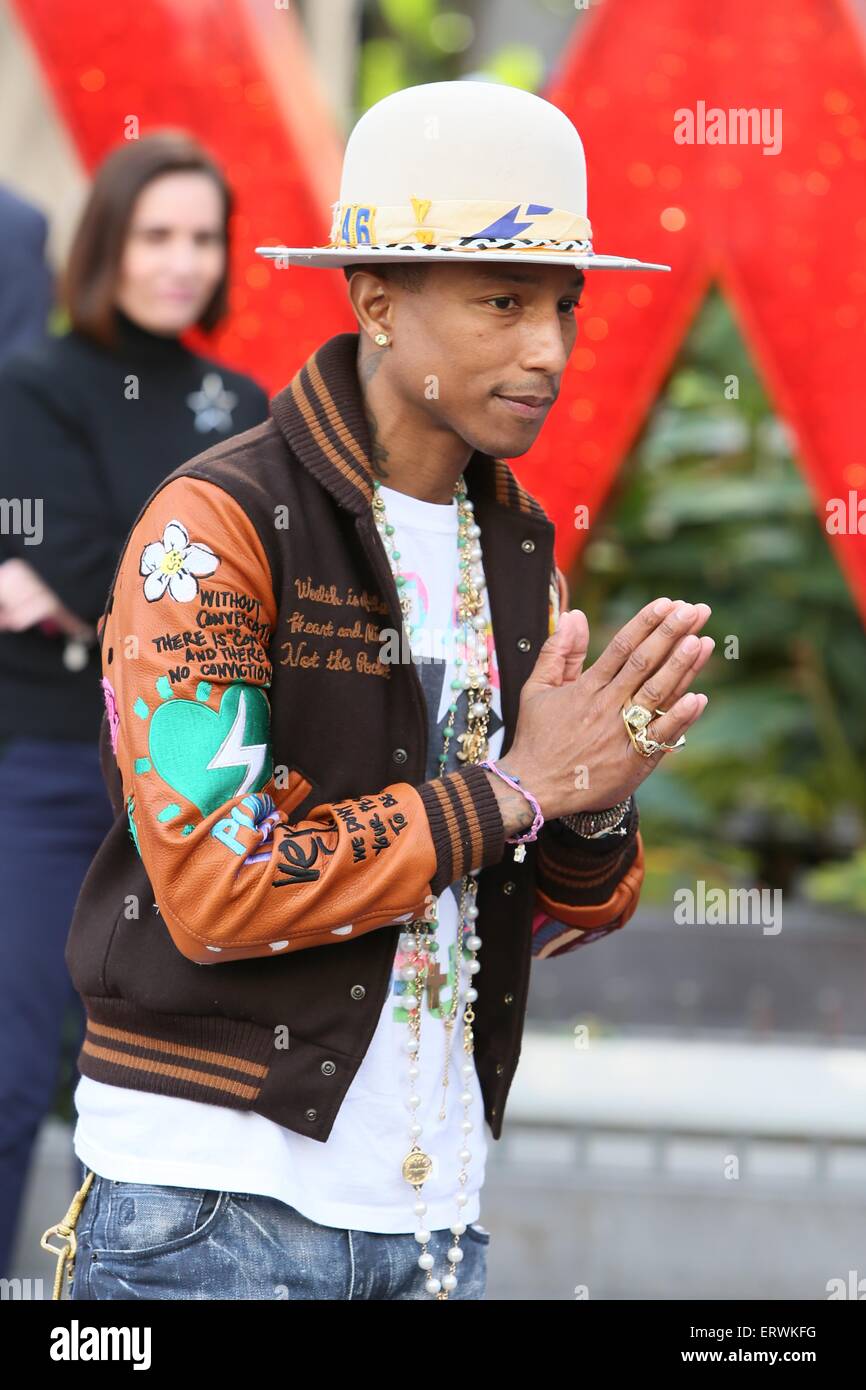 Pharrell Williams is presented with a star on the Hollywood walk of ...
