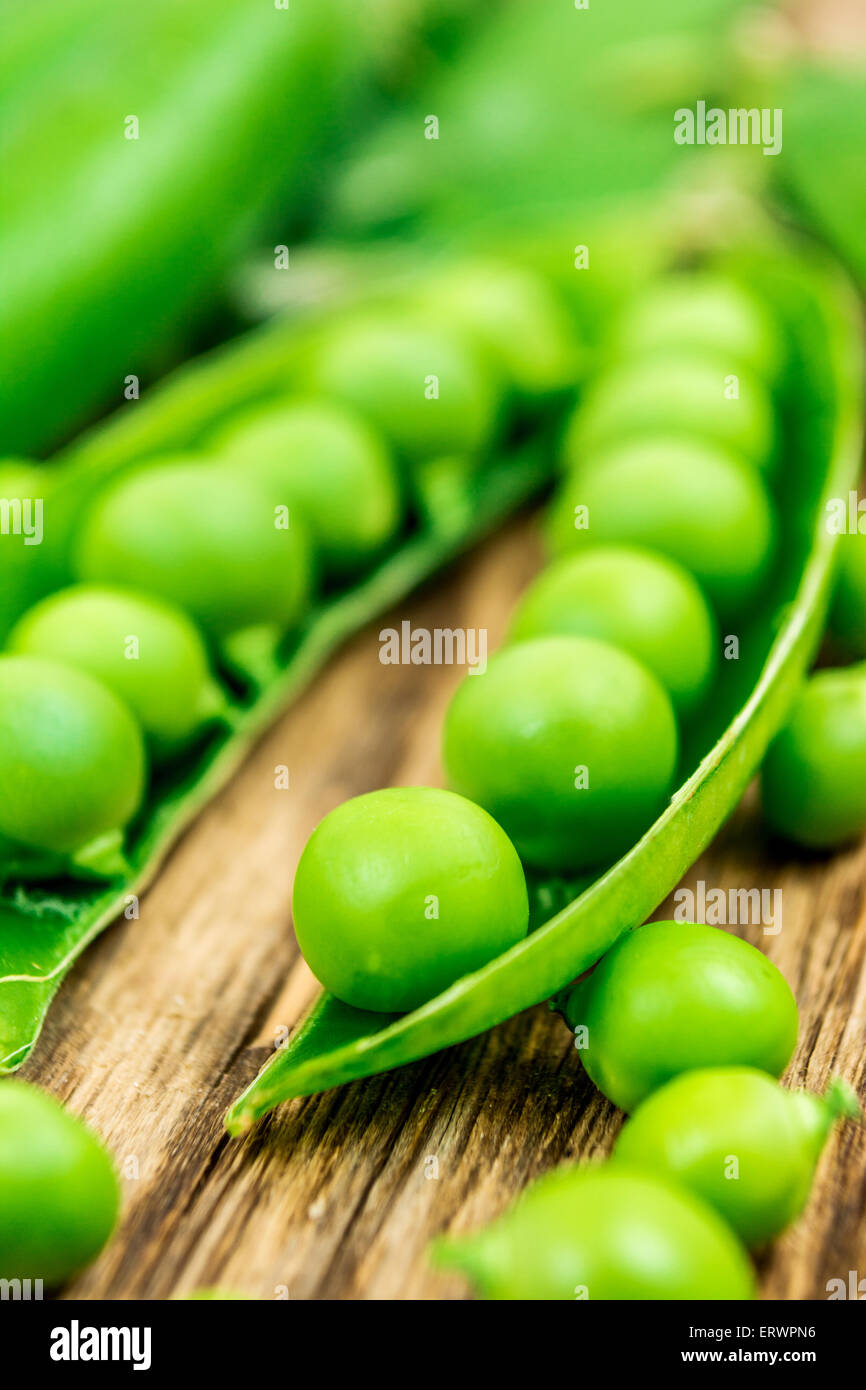 Many raw open pea on wood table Stock Photo - Alamy