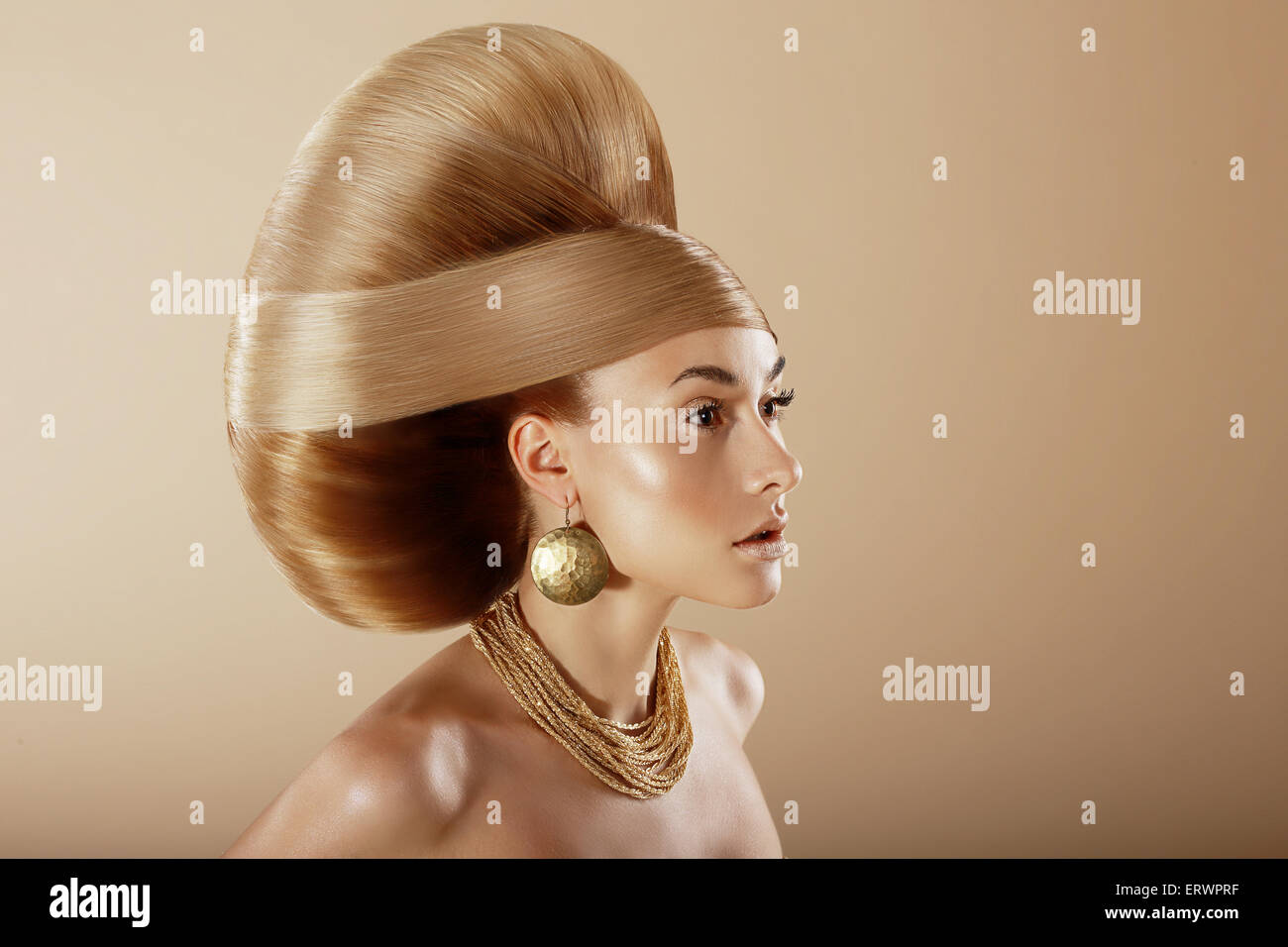 Styling. Profile of Glamorous Woman with Golden Hairdo Stock Photo - Alamy