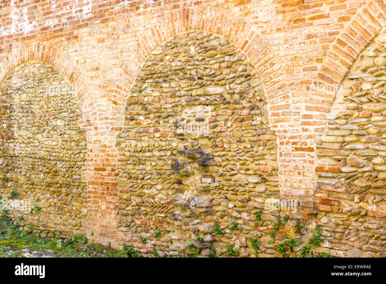 green grass and ancient brick wall of military fortification of 1400 in ...