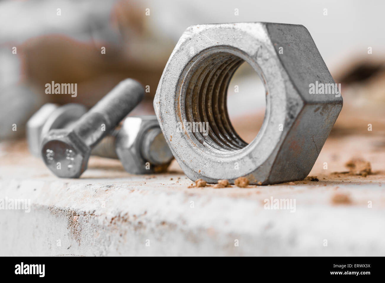 metal nut and screw closeup on a light background Stock Photo - Alamy