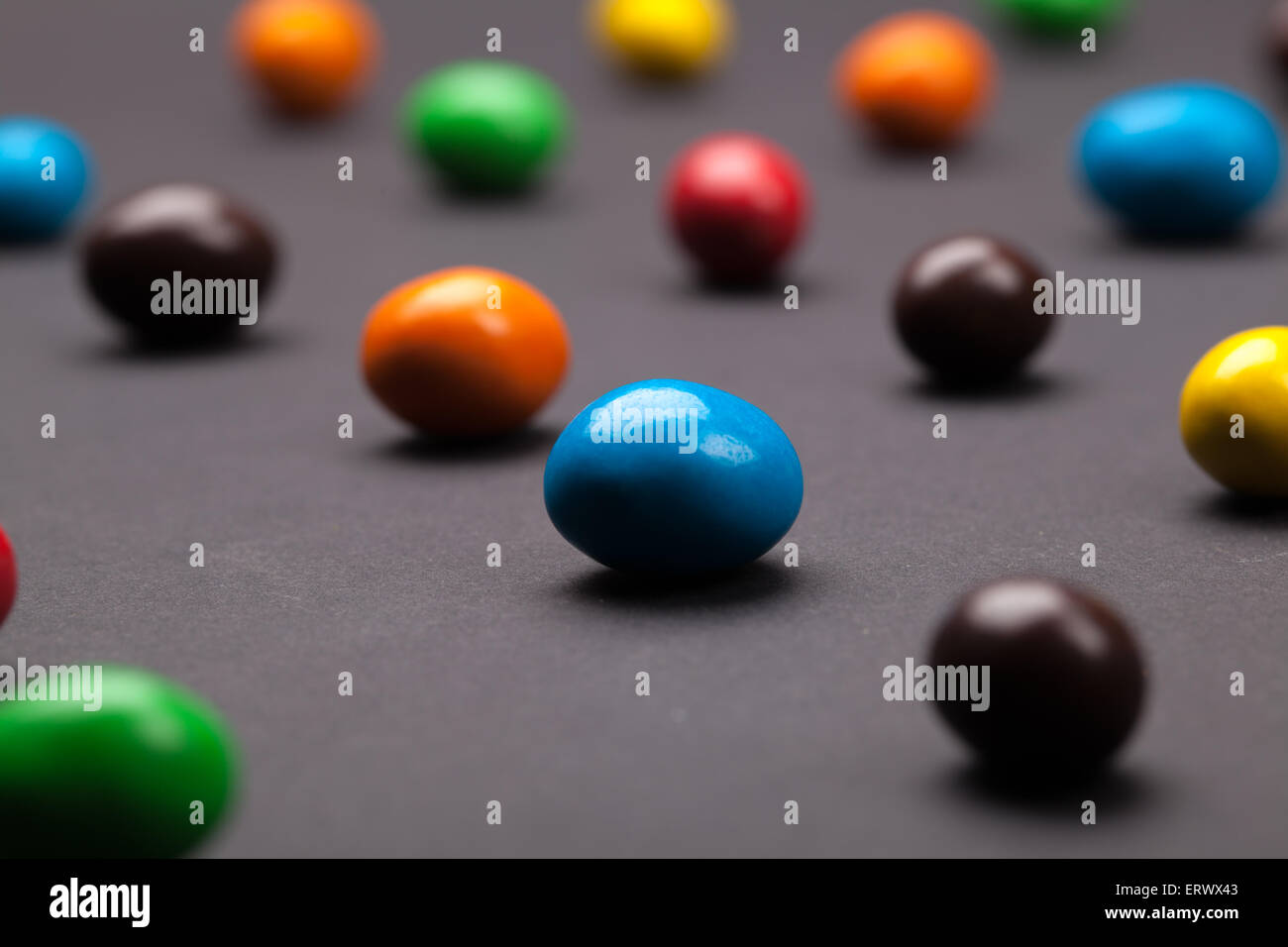 Round different colored candy close-up on a dark background Stock Photo ...