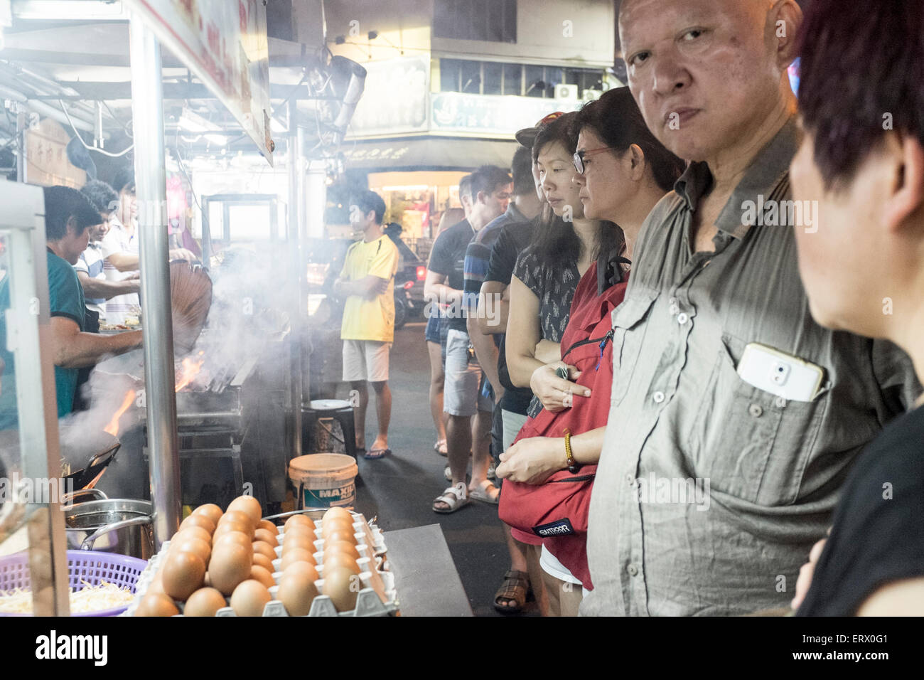 Customers line up at a street food stall on Lorong Baru in Penang ...