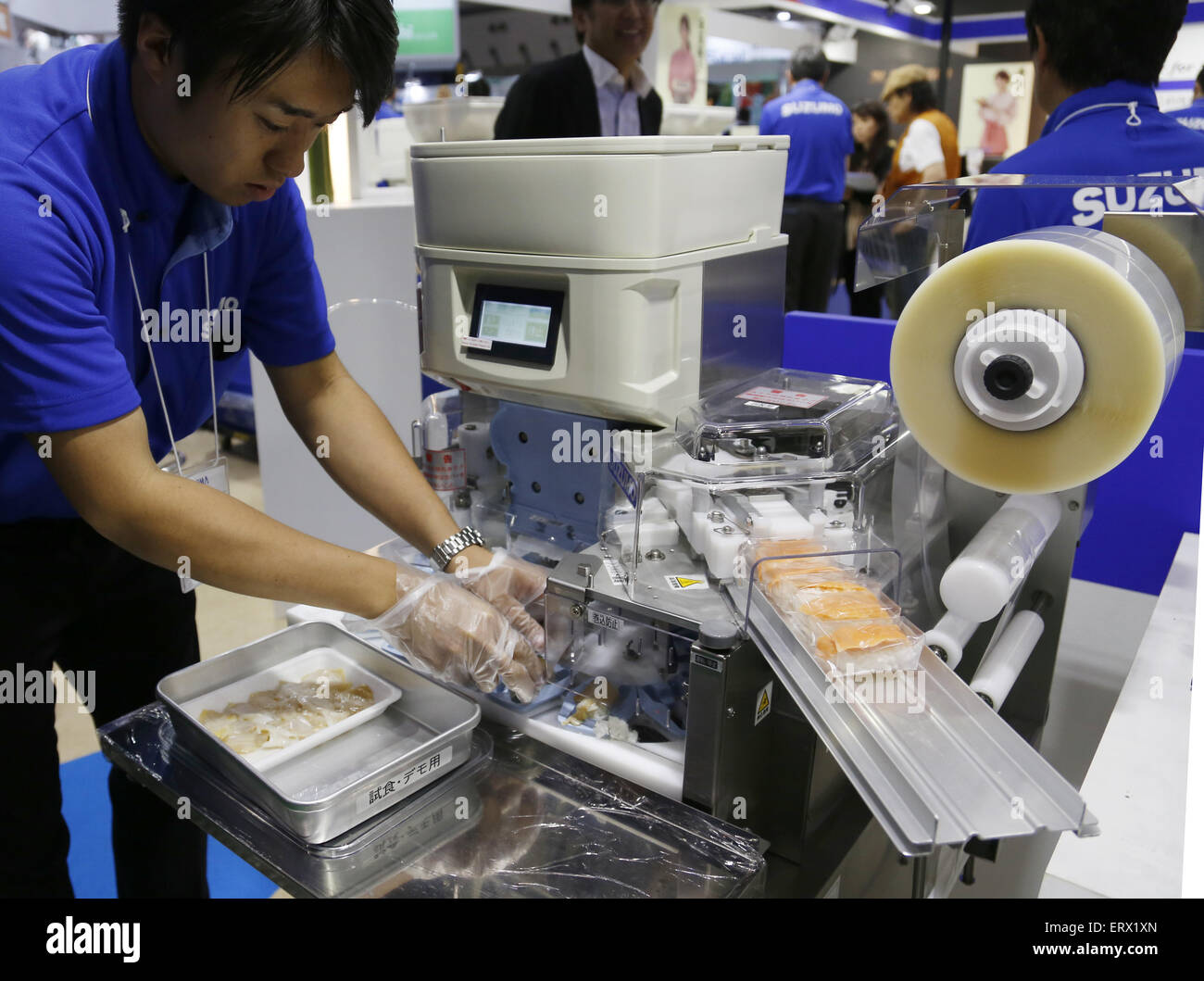 Tokyo, Japan. 9th June, 2015. A staff operates a sushi robot at the ...