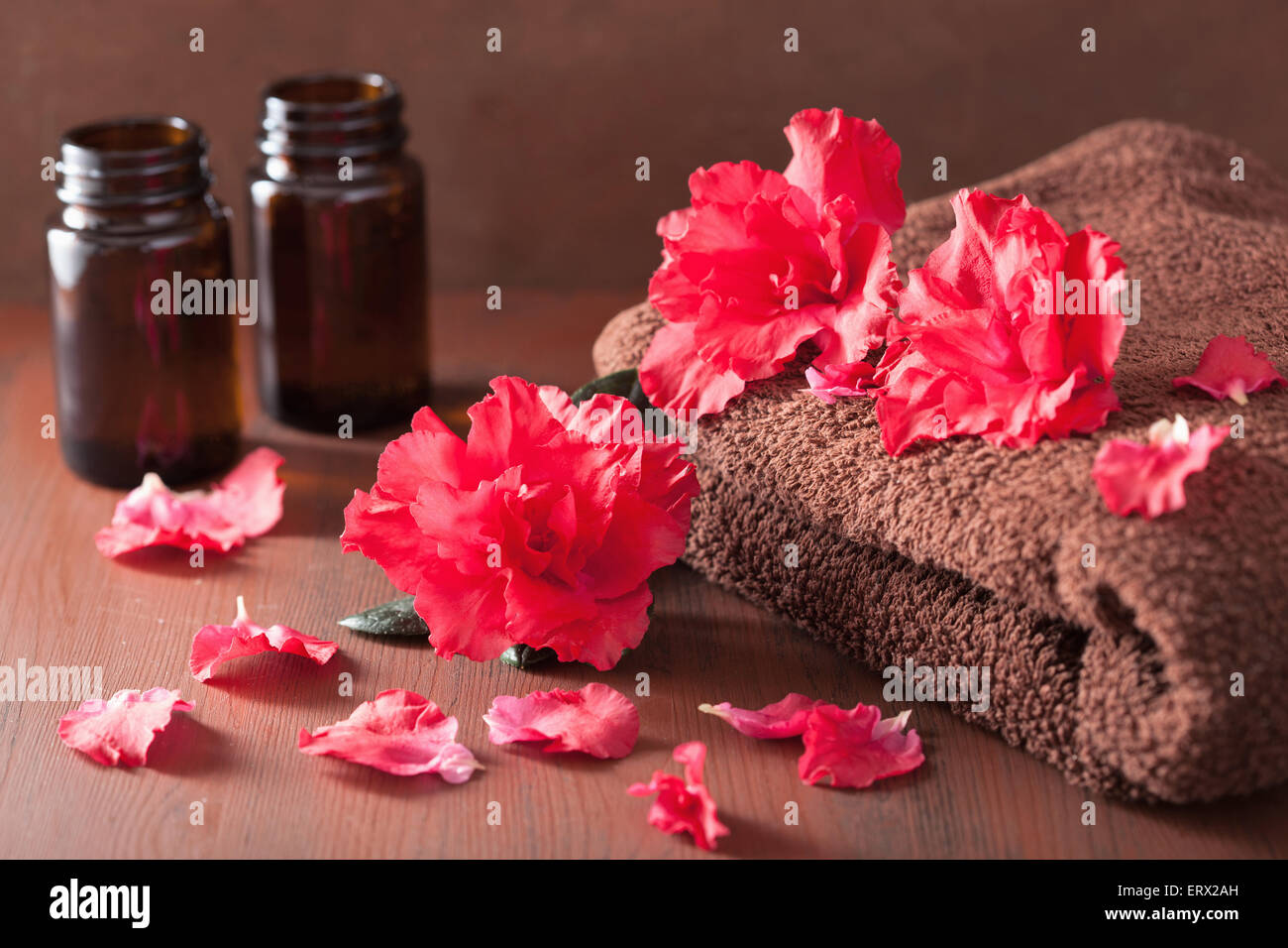 spa bathroom with azalea flowers essential oil on dark rustic ...
