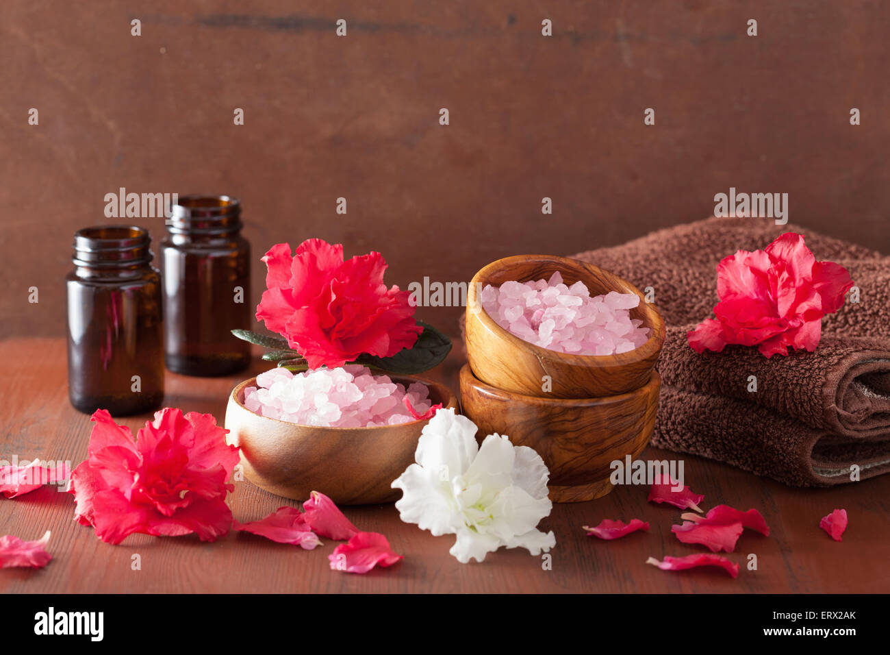 spa aromatherapy with azalea flowers and herbal salt on rustic dark ...