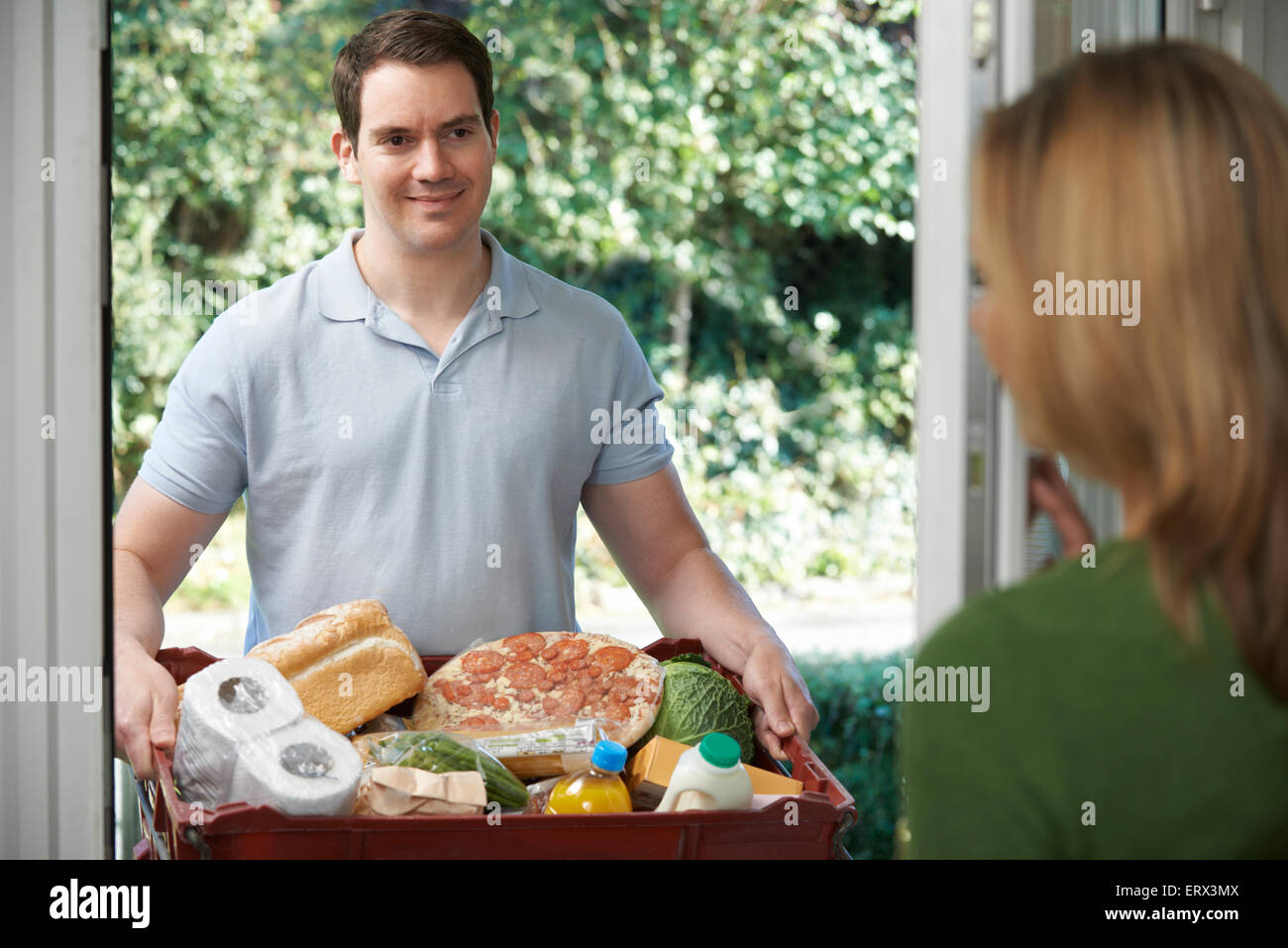 Women delivering groceries to man hi-res stock photography and images ...