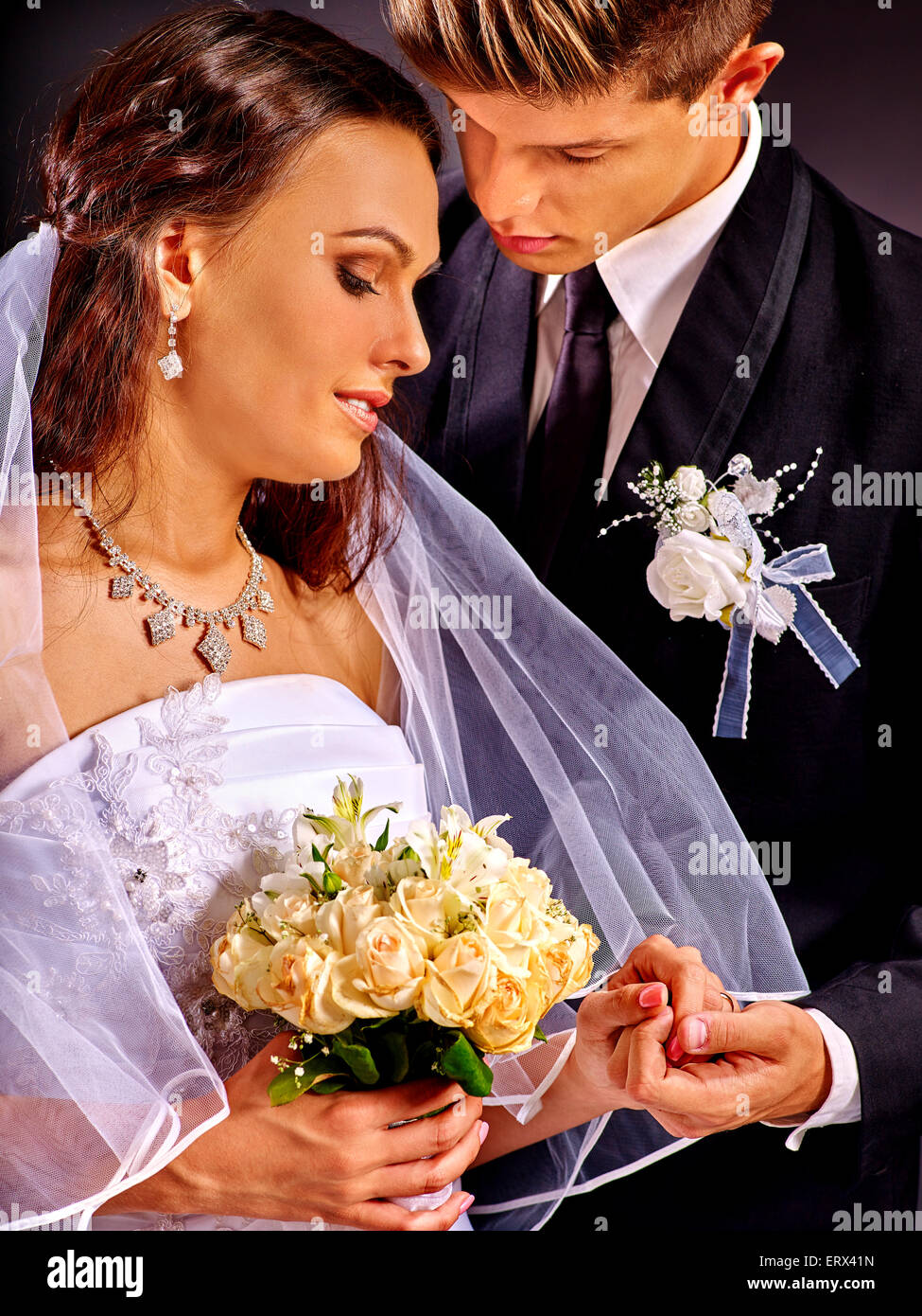 Groom embracing bride Stock Photo - Alamy