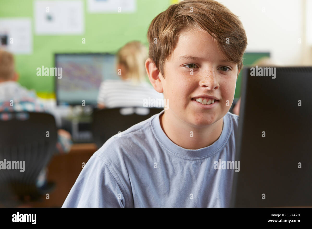 Male Elementary School Pupil In Computer Class Stock Photo - Alamy