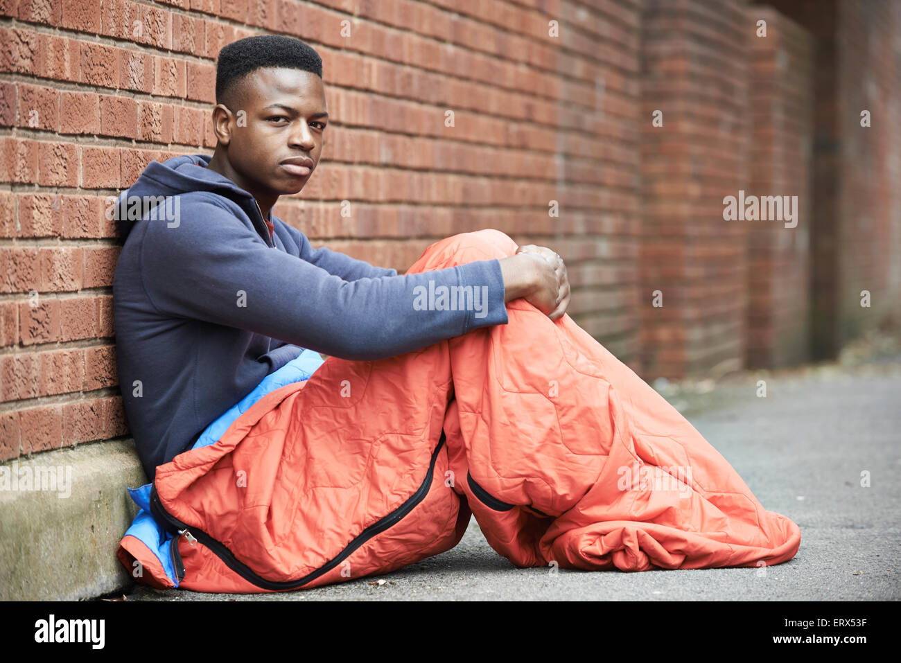 Vulnerable Teenage Boy Sleeping On The Street Stock Photo - Alamy