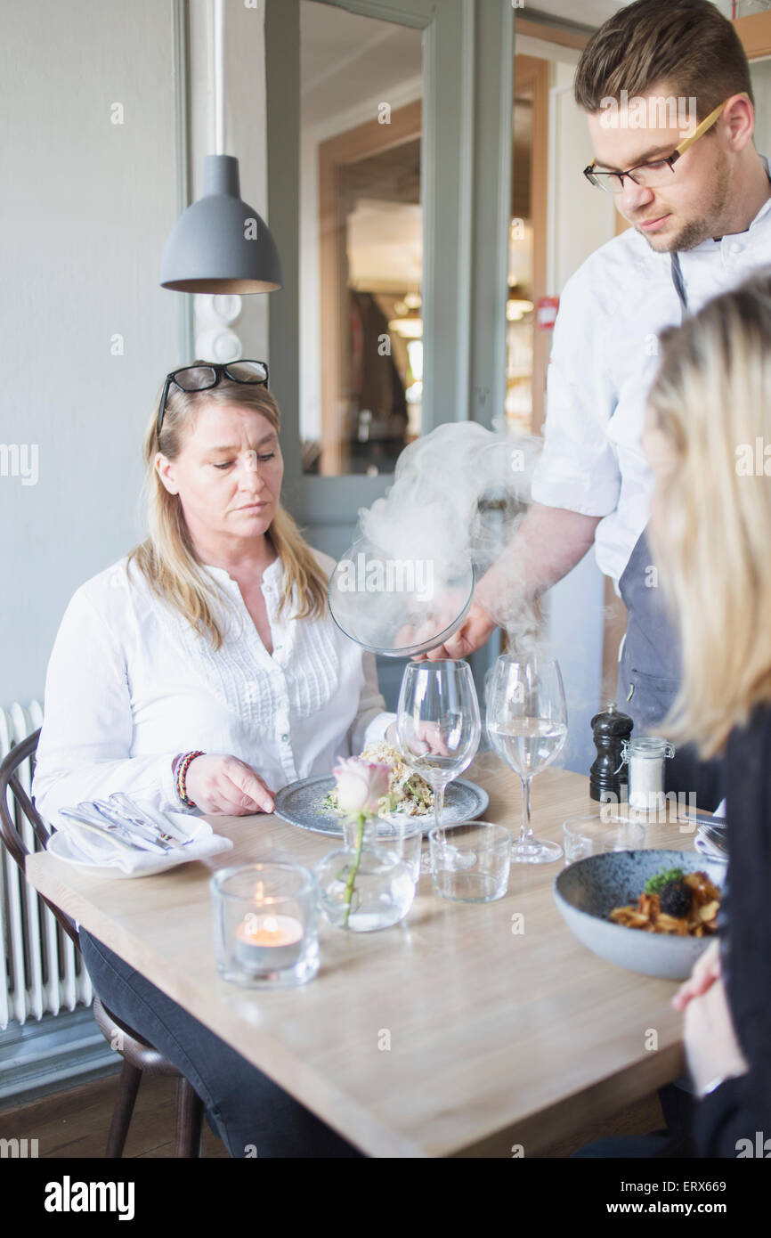 Waiters serving food to customers hi-res stock photography and images ...