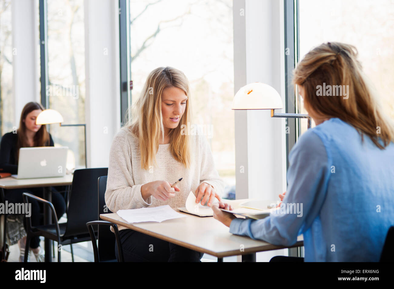 Two adults reading in library hi-res stock photography and images - Alamy