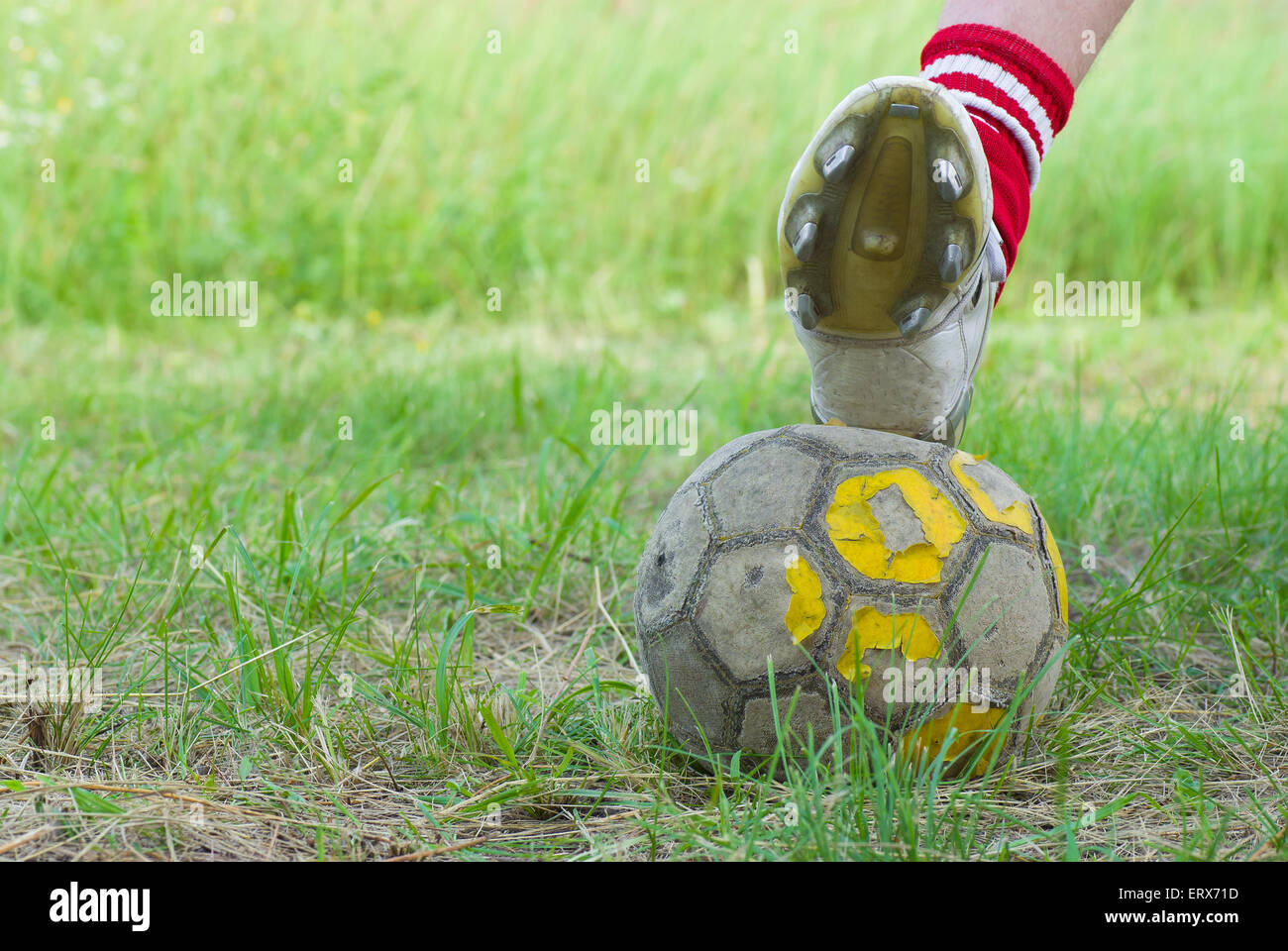 Soccer on old and bad field with shabby ball closeup Stock Photo - Alamy