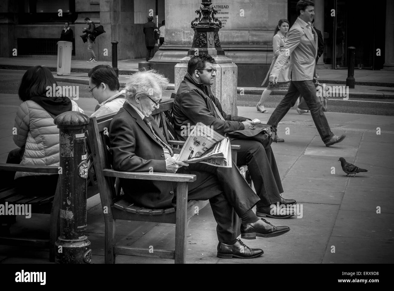 Reading newspaper on bench hi-res stock photography and images - Alamy