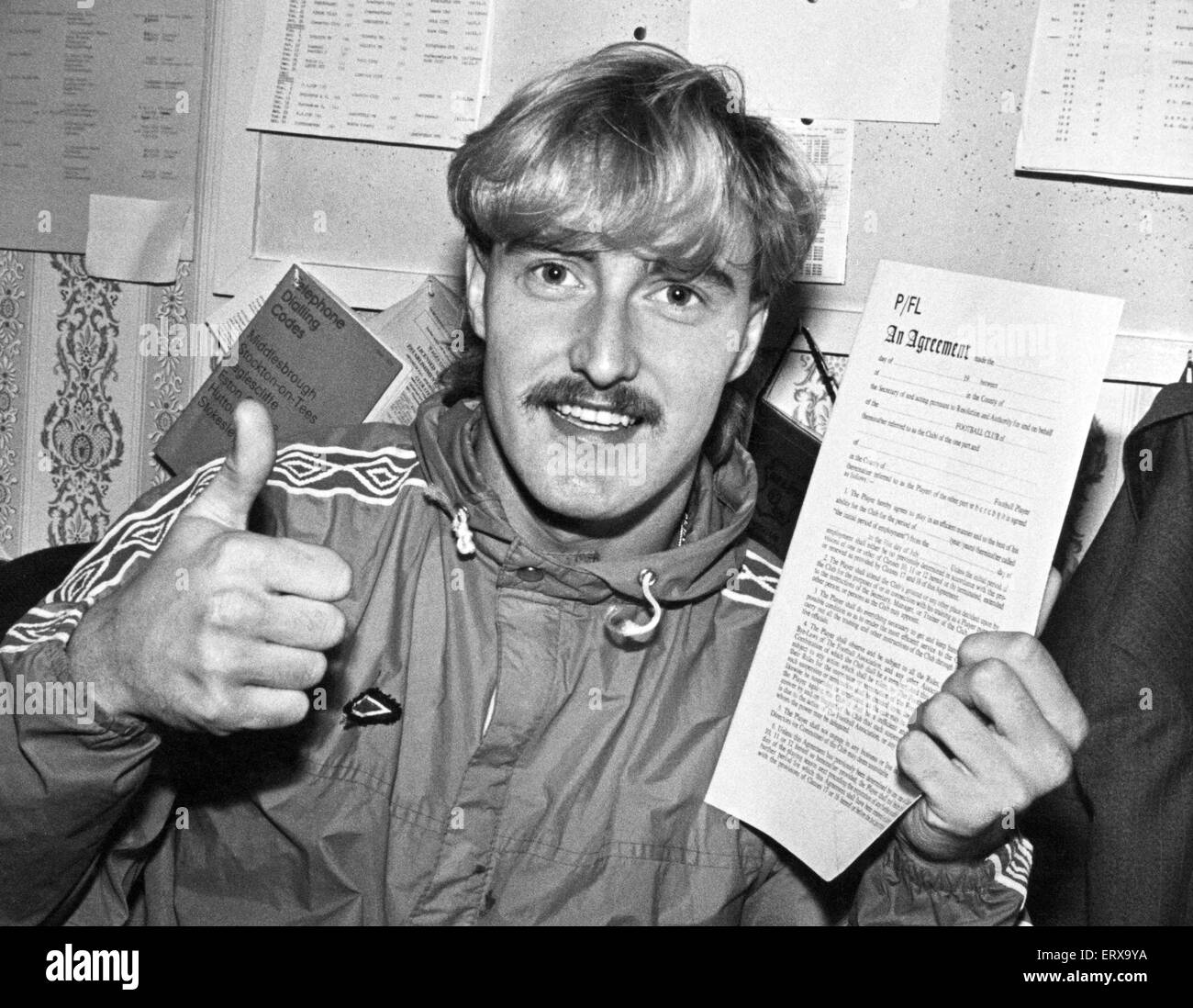 David Hodgson holding up a contract, giving a thumbs up sign, circa ...
