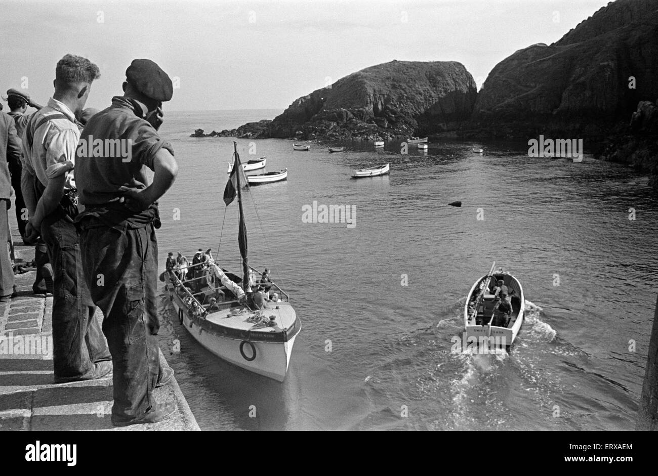 People watch the boats off the coast of Sark, Channel Islands. July ...