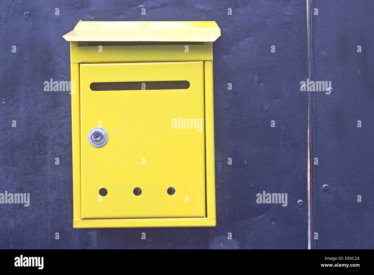 Yellow mailboxes on blue metal background Stock Photo - Alamy