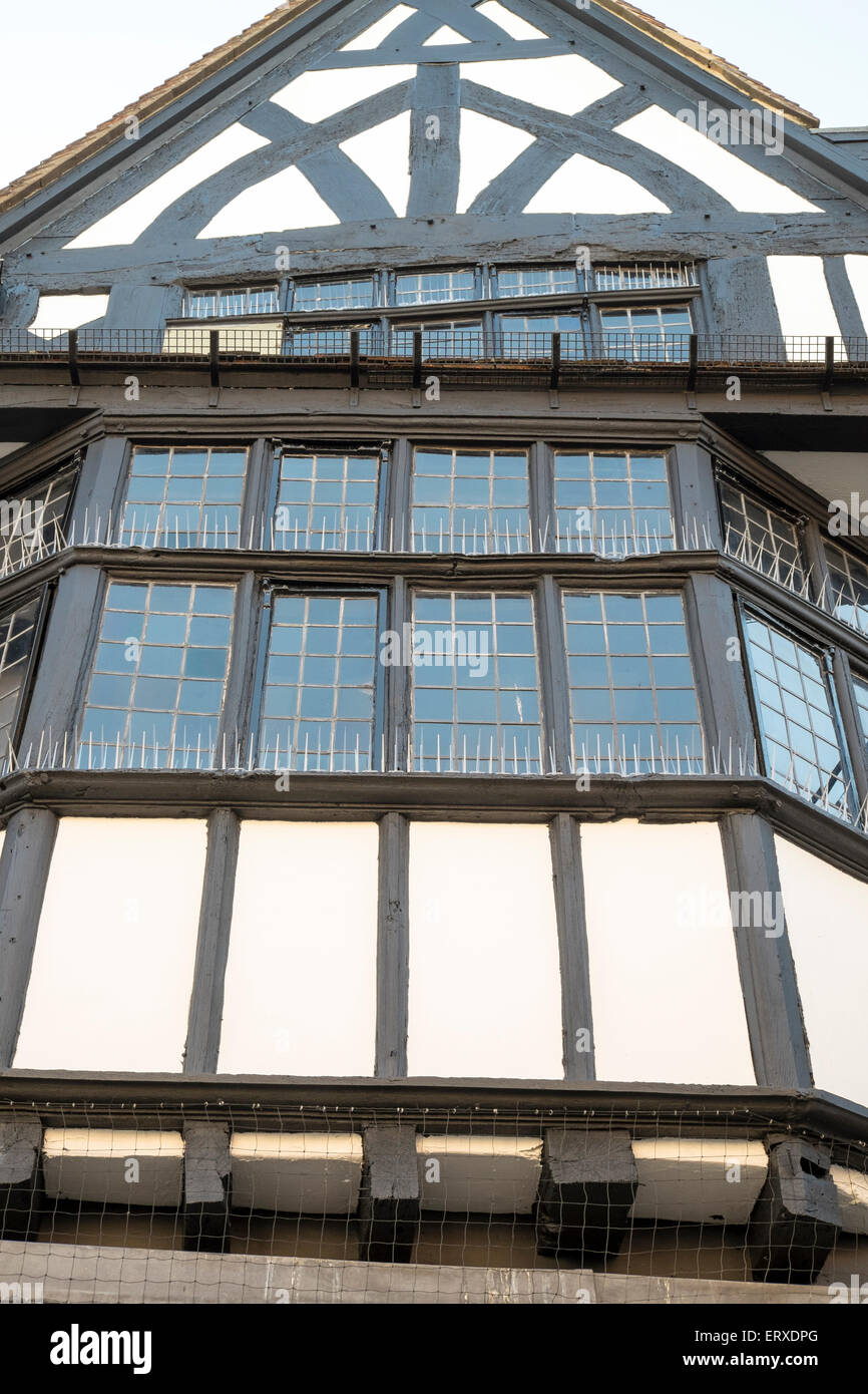 Tudor style timbered building with leaded windows and rows of spikes in ...