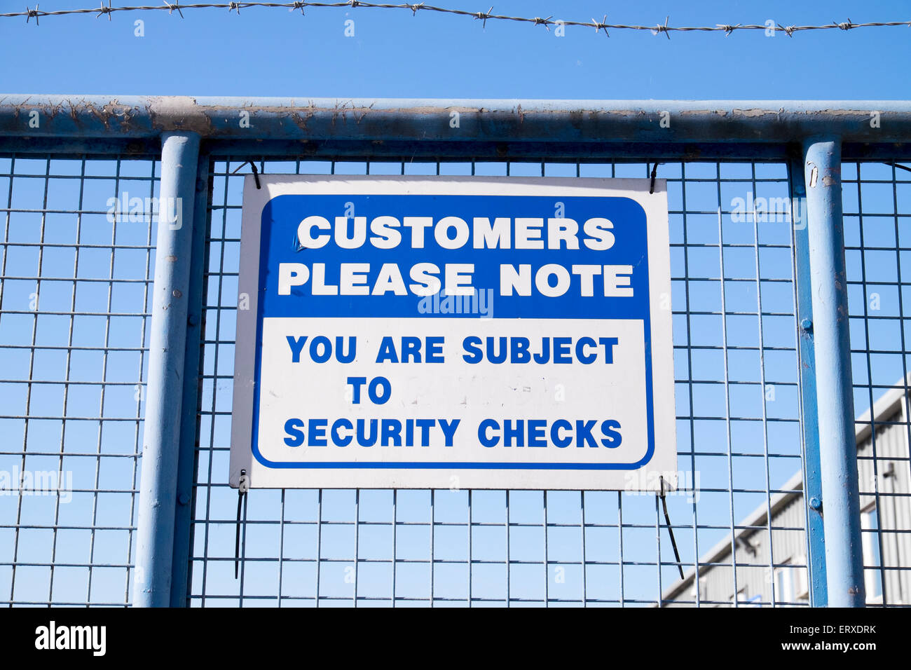 Customer security check notice on metal gate Stock Photo - Alamy