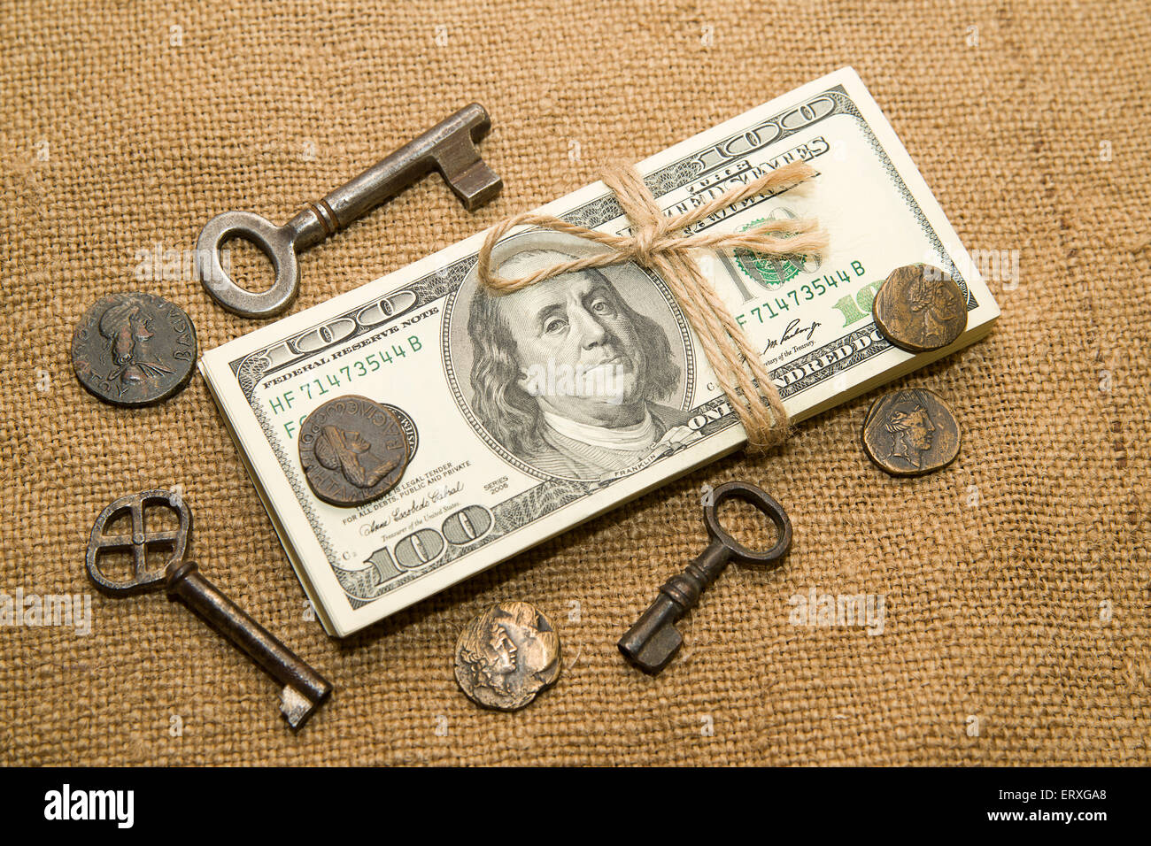 One pack of dollars tied up with rope, coins and keys in the old cloth ...