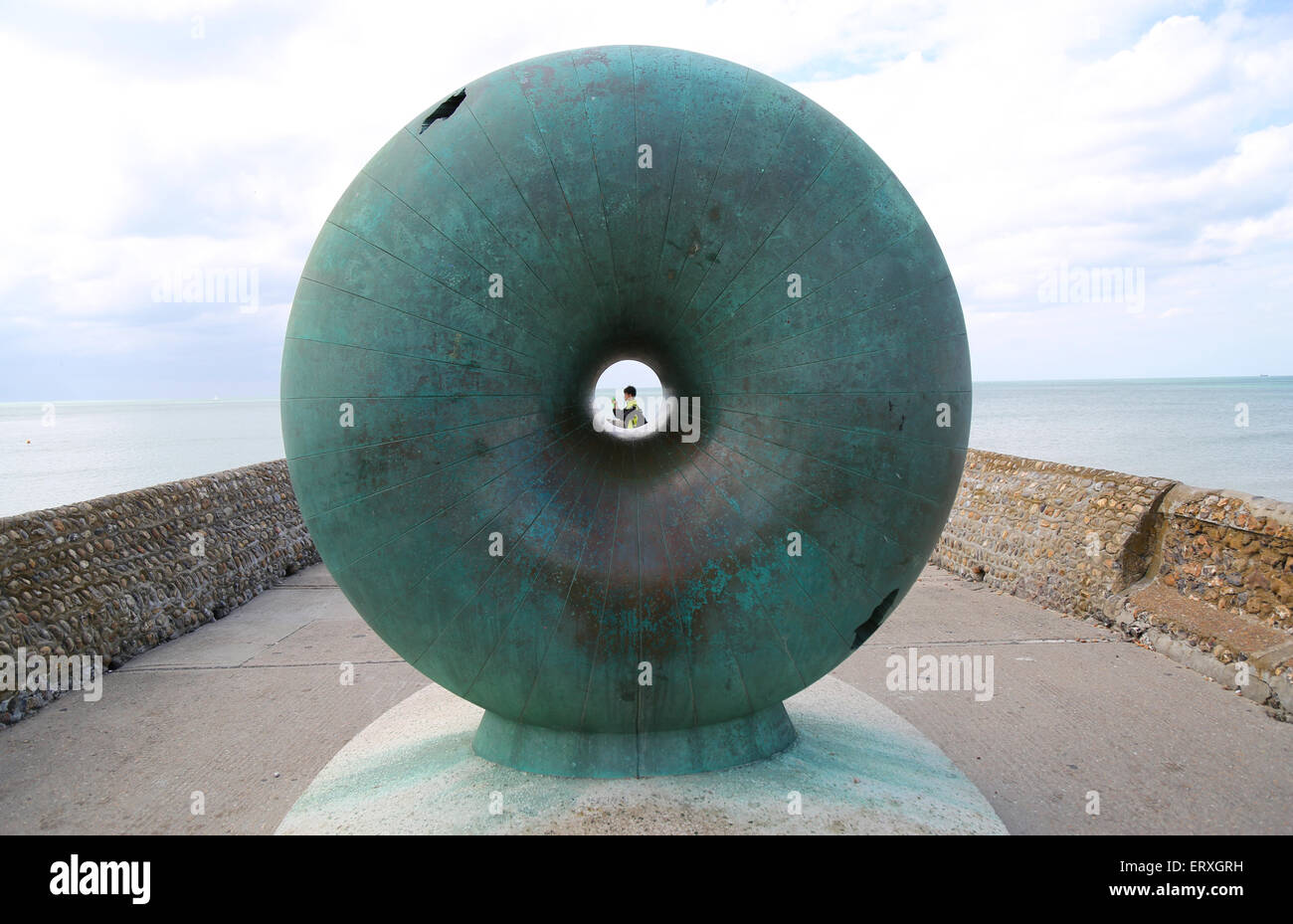 "Afloat" a huge circular donut shaped globe cast in bronze on a groyne ...