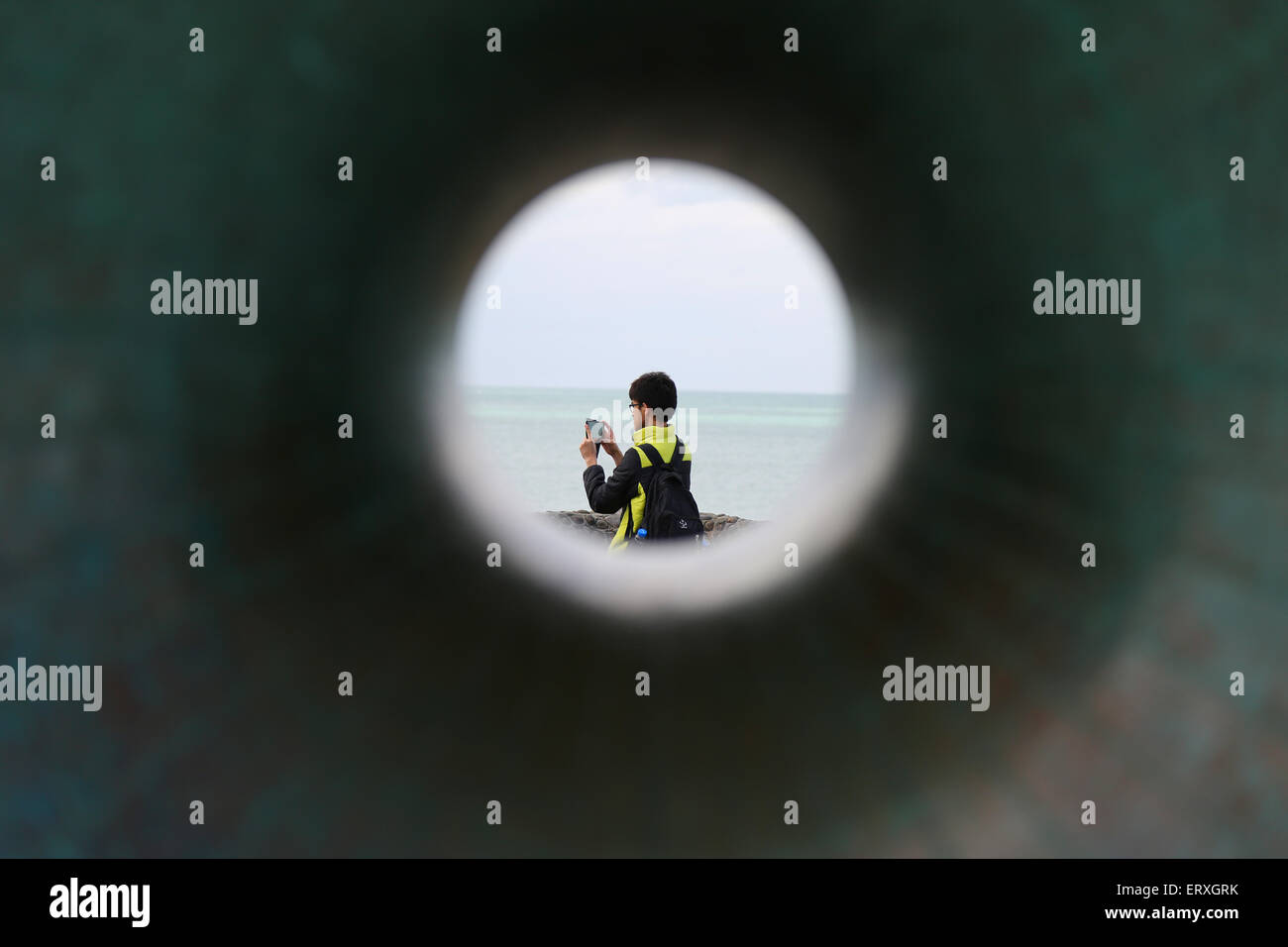 "Afloat" a huge circular donut shaped globe cast in bronze on a groyne ...