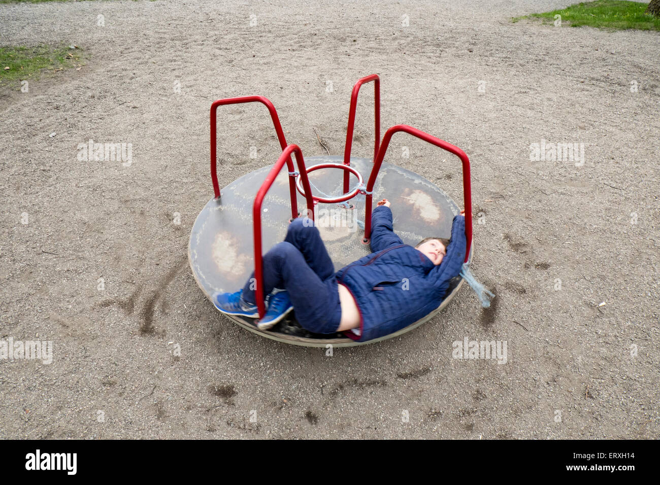 boy resting on carousel Stock Photo - Alamy