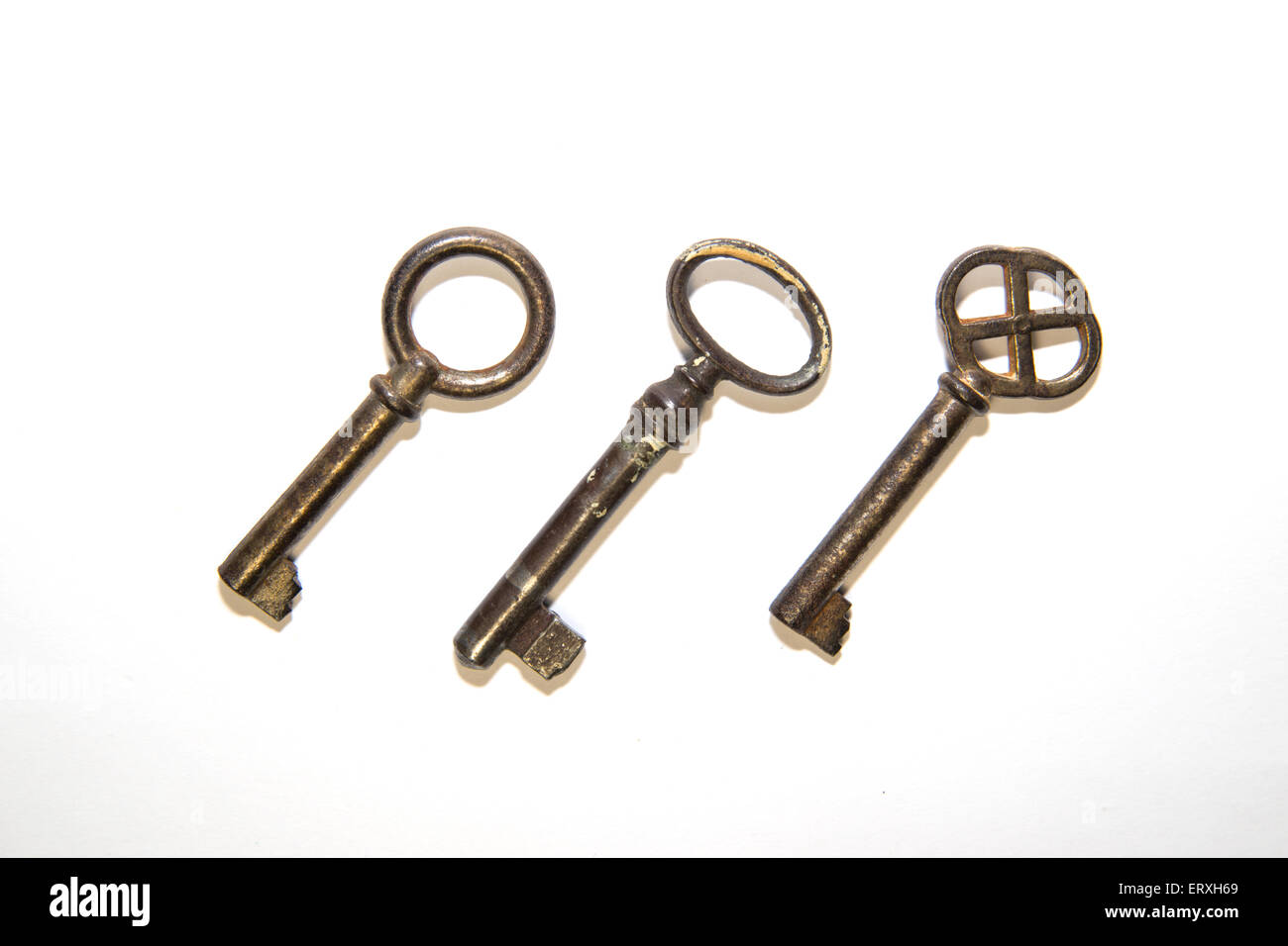 Three vintage keys on a white background Stock Photo - Alamy