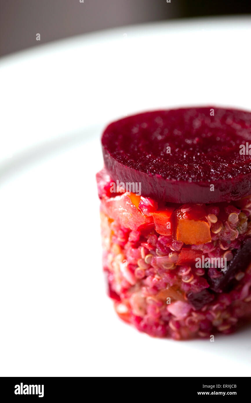Cake of tomato and quinoa, beet slice Stock Photo - Alamy