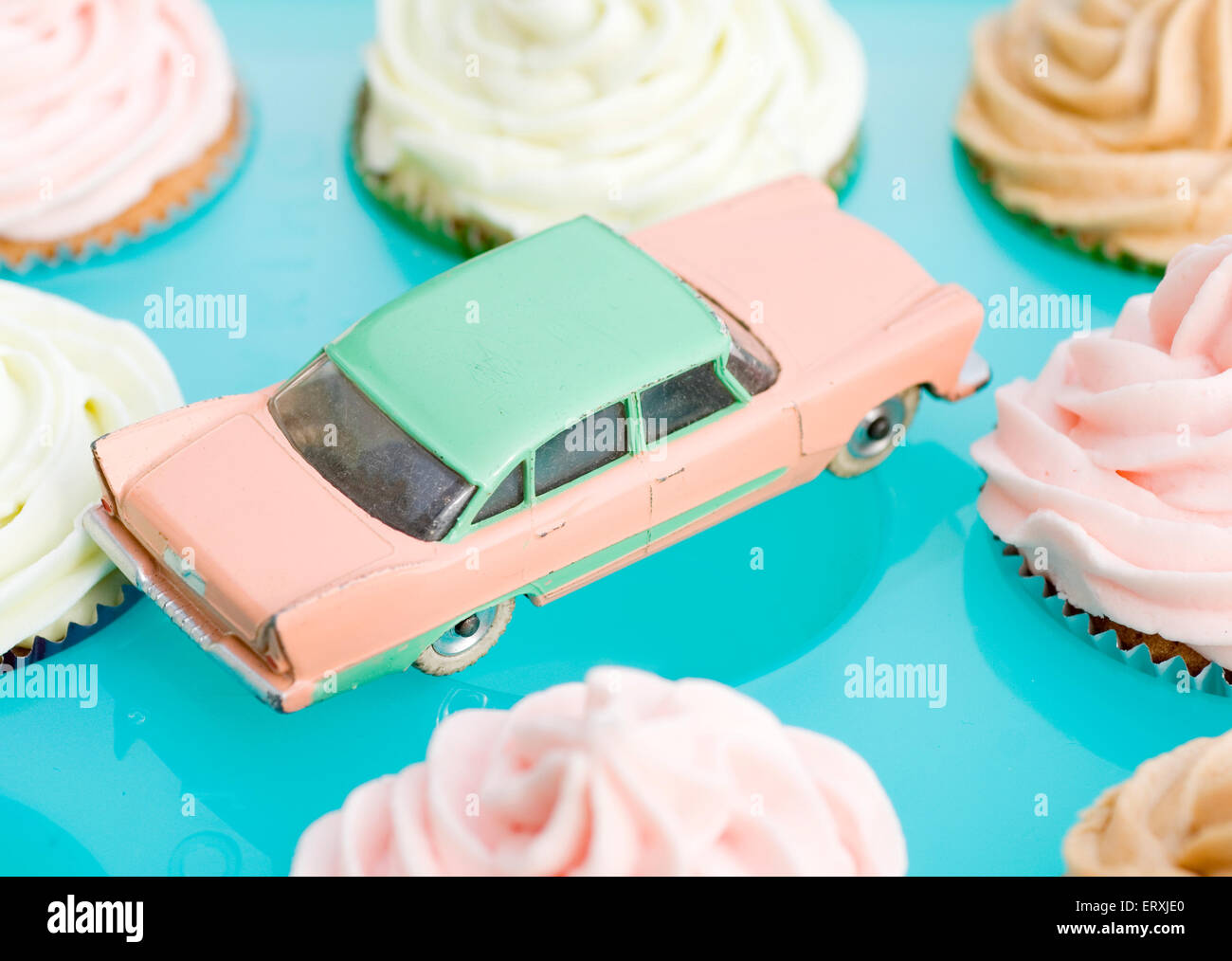 Dinky Plymouth Plaza toy car surrounded by iced cup cakes in pastel ...