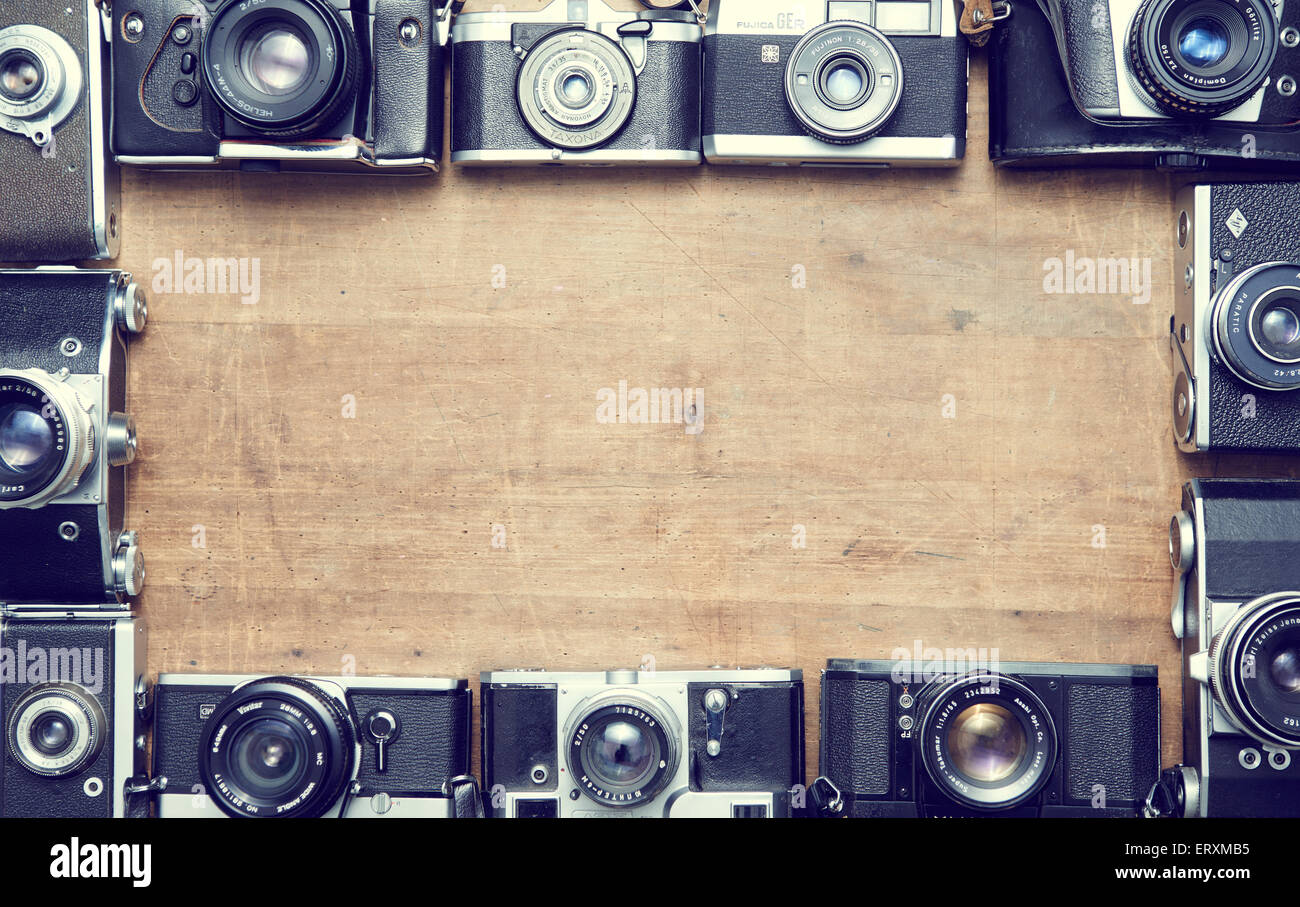 Old retro film analogue cameras collection on vintage wooden desk ...