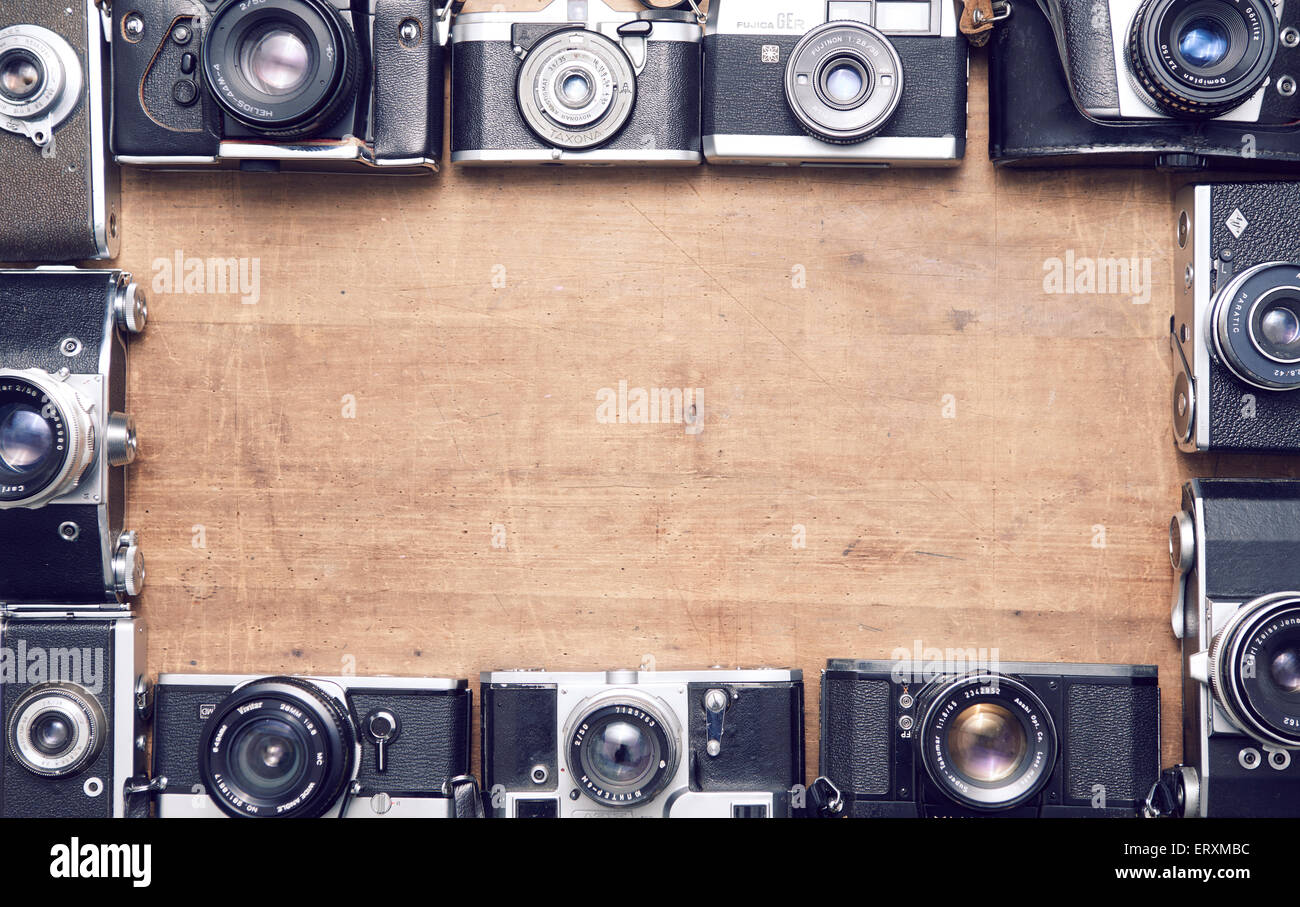 Old retro film analogue cameras collection on vintage wooden desk ...
