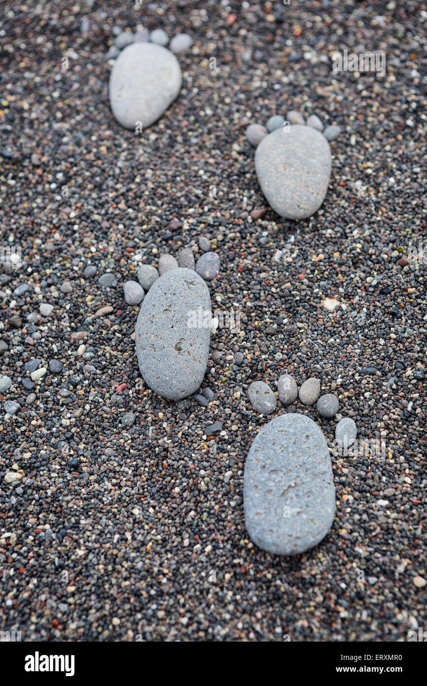 Footprint on wet sea pebbles, small stones Stock Photo - Alamy