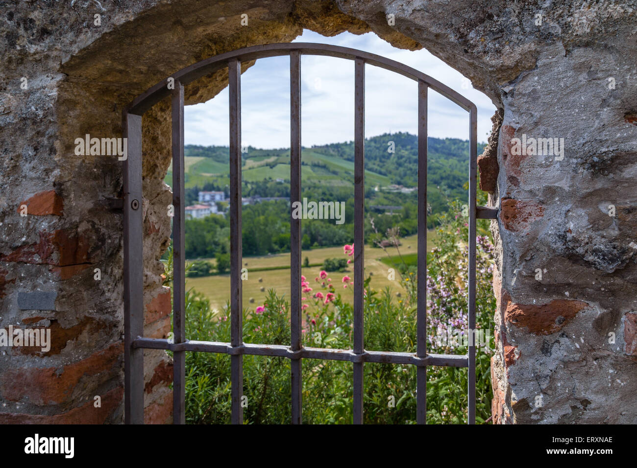 Medieval window with iron grating overlooking the countryside of ...