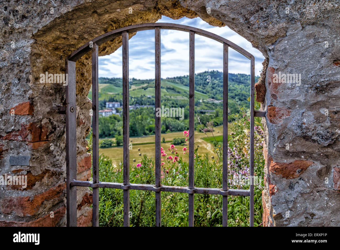 Medieval window with iron grating overlooking the countryside of ...