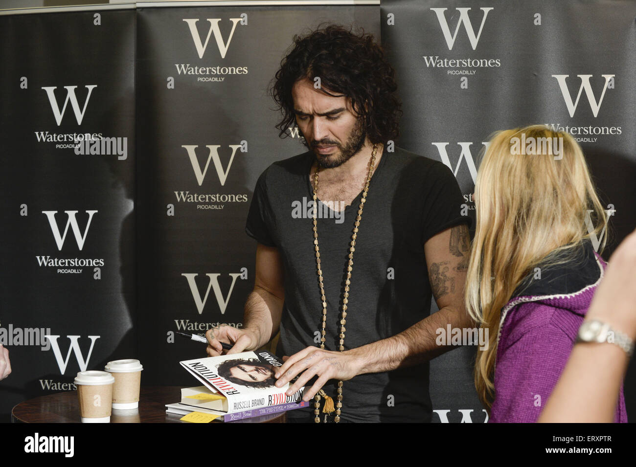 Russell Brand signs copies of his new books 'Revolution' and 'The Pied ...